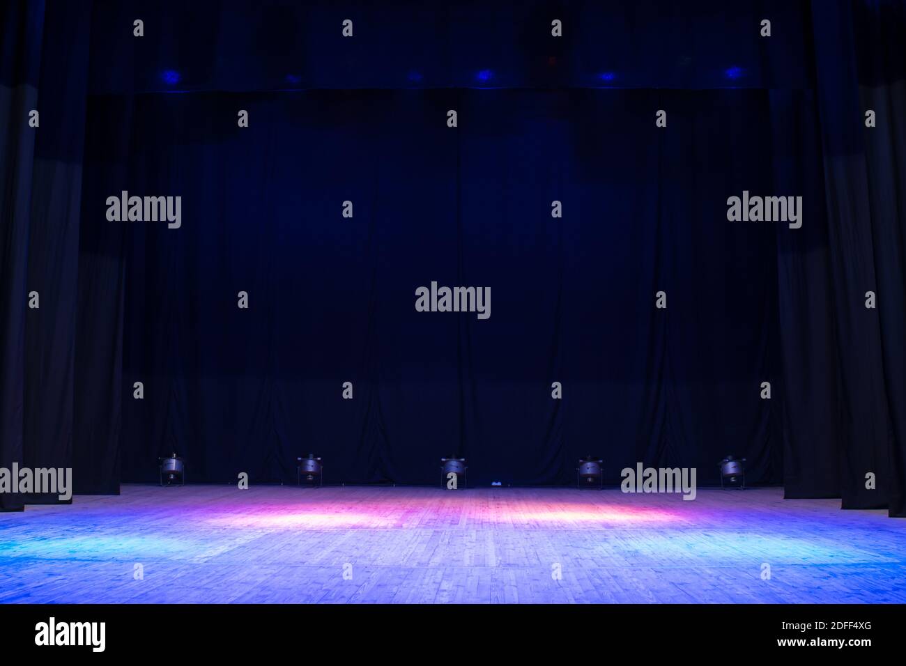 An empty stage of the theater, lit by spotlights before the performance ...