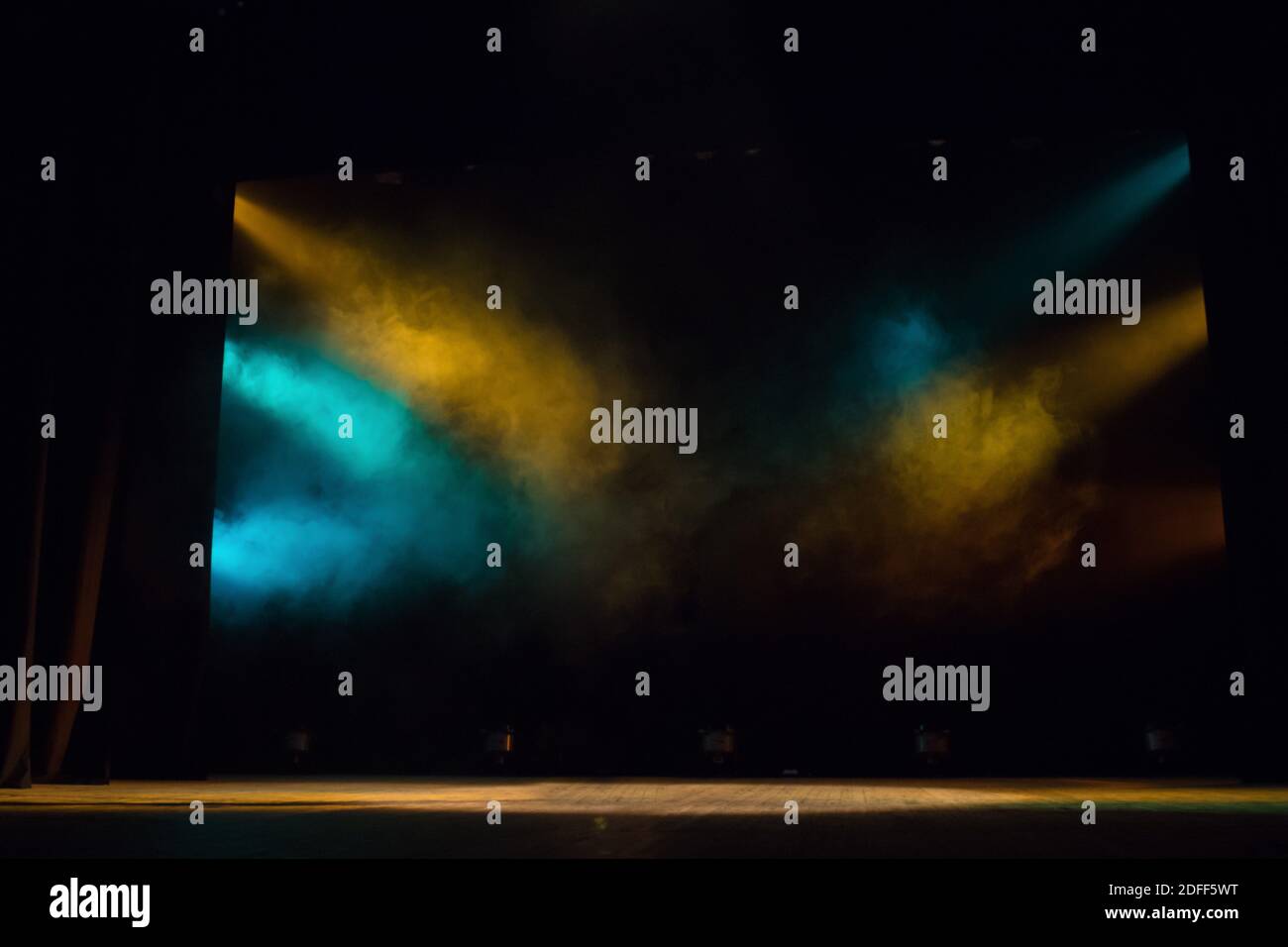 An empty stage of the theater, lit by spotlights and smoke before the ...