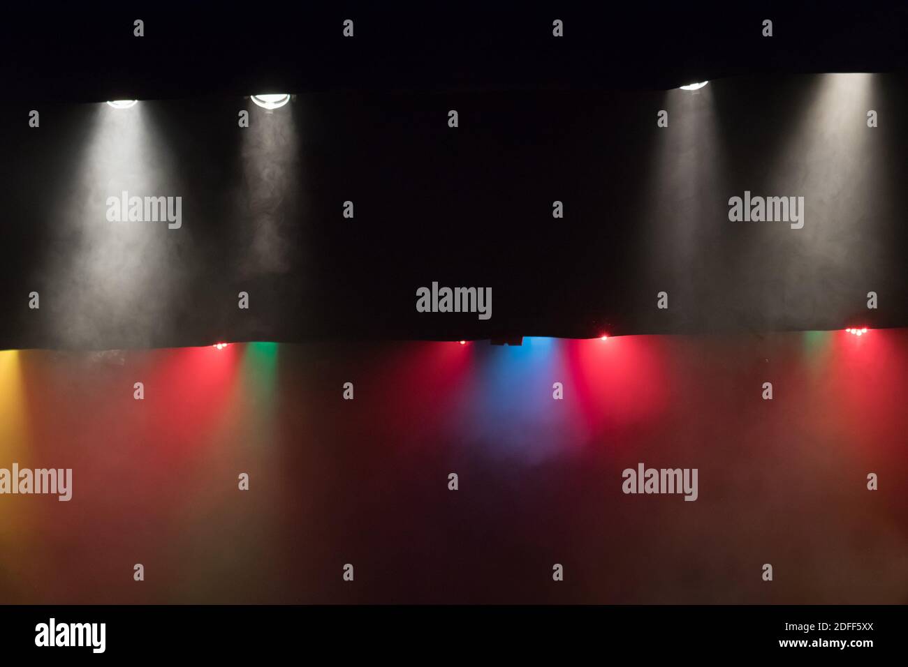 An empty stage of the theater, lit by spotlights and smoke before the ...