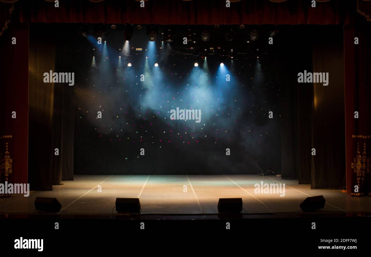 An empty stage of the theater, lit by spotlights and smoke before the ...