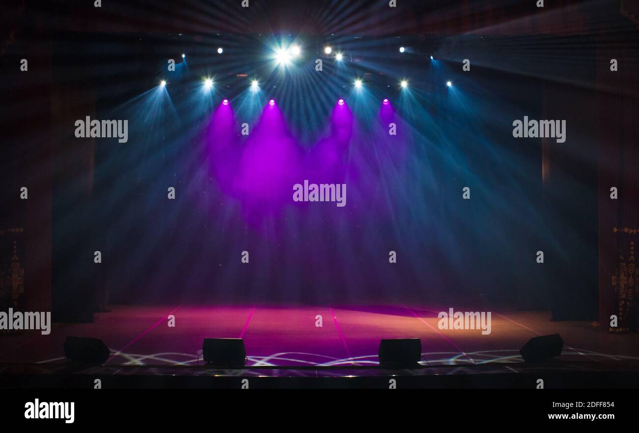 An empty stage of the theater, lit by spotlights and smoke before the ...