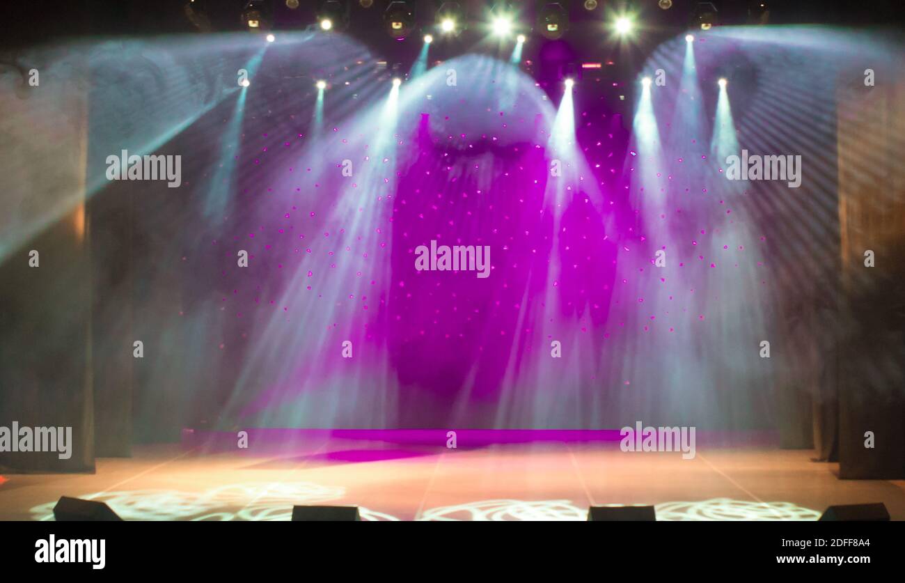 An empty stage of the theater, lit by spotlights and smoke before the ...