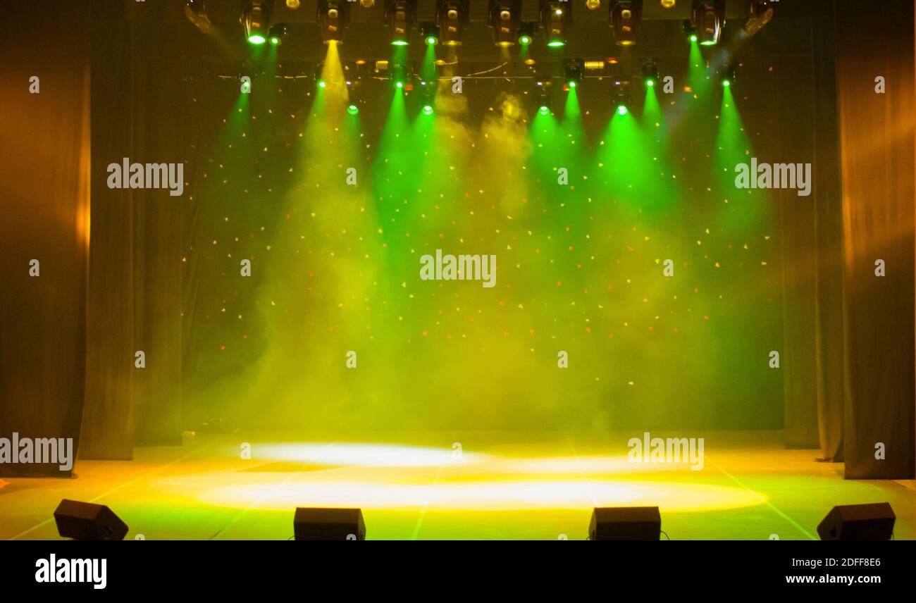 An empty stage of the theater, lit by spotlights and smoke before the ...
