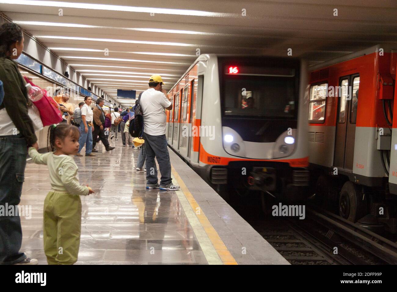 Mexico DF State/Mexico 12/27/2009. Train arriving and people walking ...