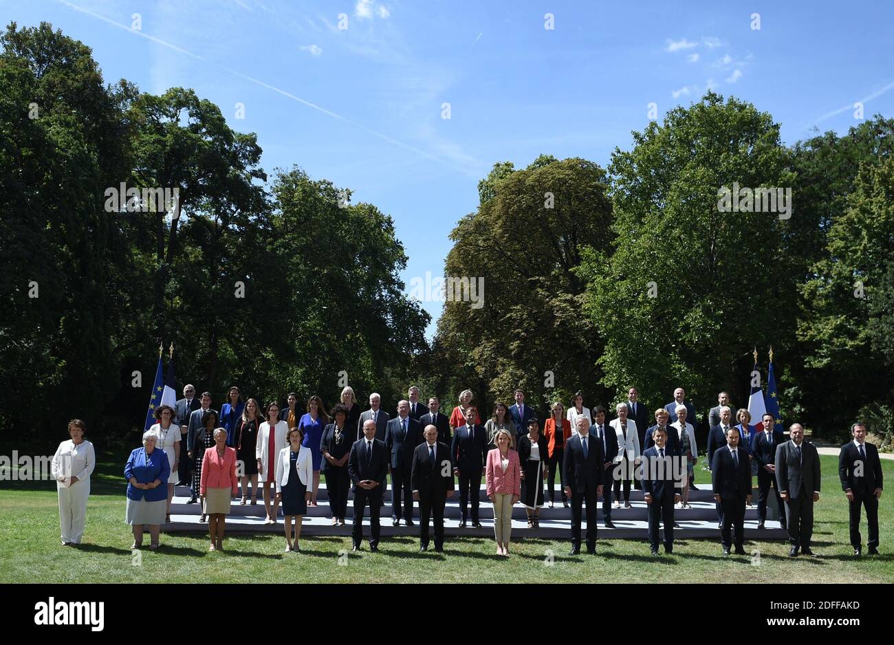French President Emmanuel Macron (C) poses with members of the cabinet ...