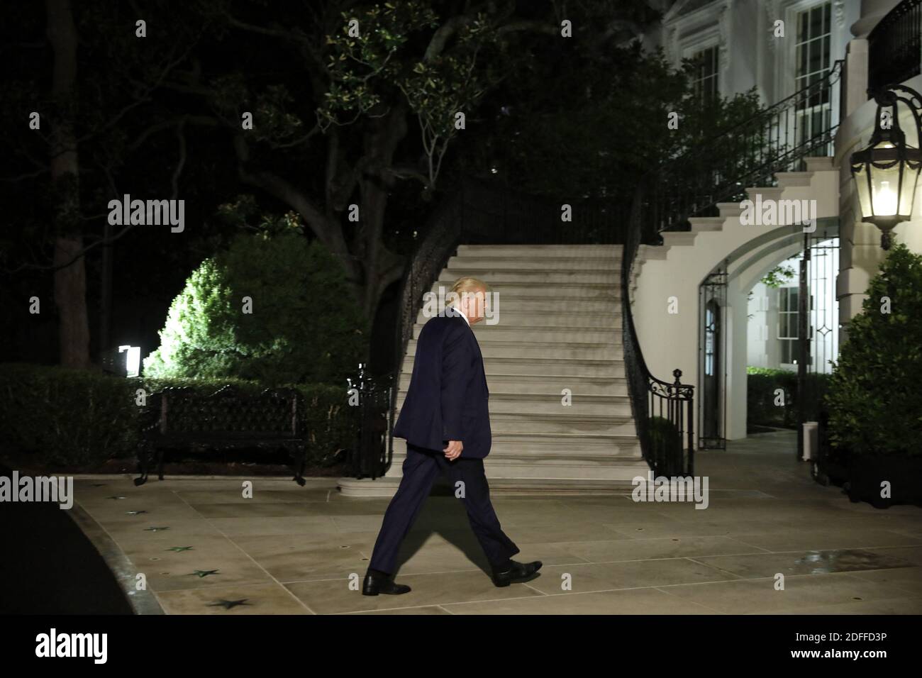 U.S. President Donald Trump enters the White House upon his return to ...