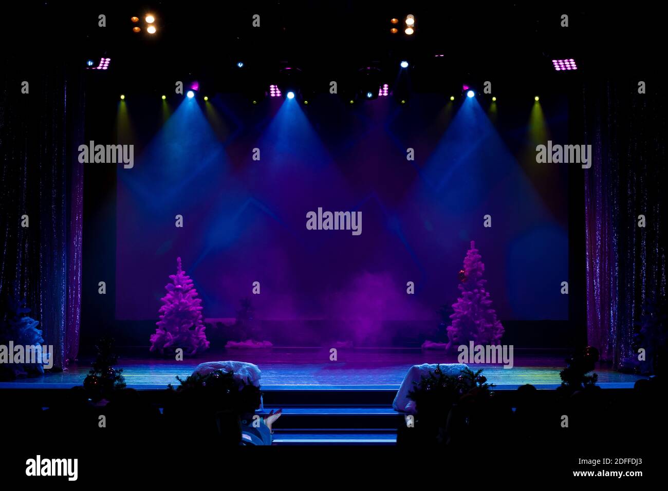 scene, stage light with colored spotlights and smoke, christmas tree ...