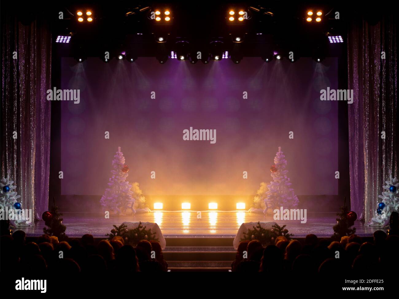 A theater stage with a curtain illuminated by stage light and smoke ...