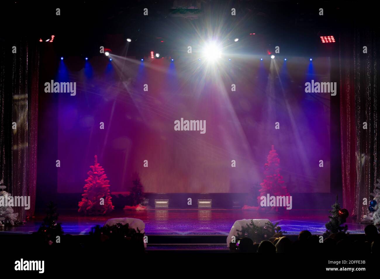 scene, stage light with colored spotlights and smoke, christmas tree ...