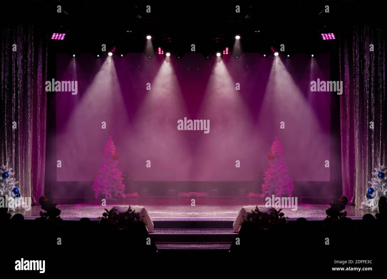 A theater stage with a curtain illuminated by stage light and smoke ...