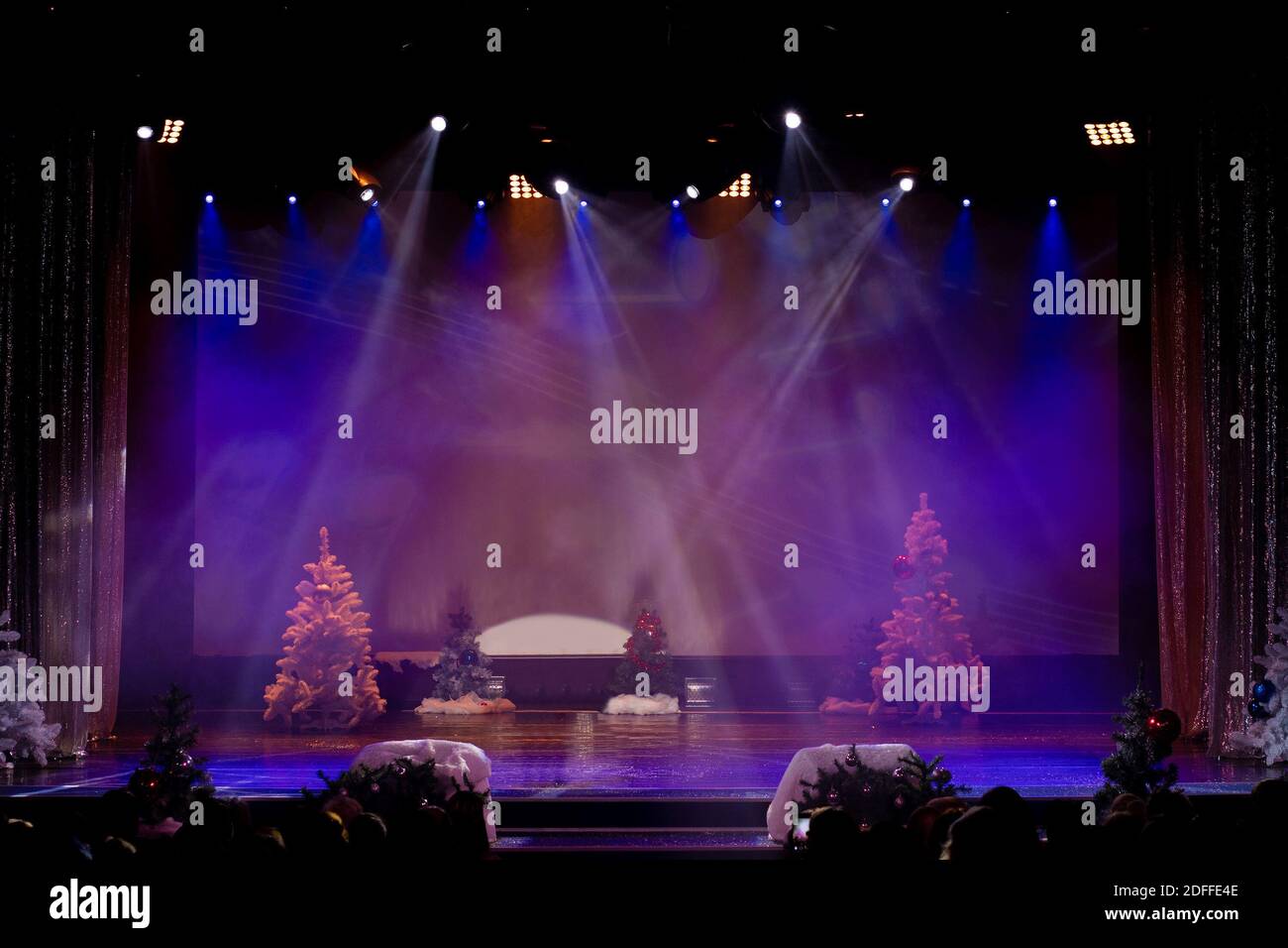 scene, stage light with colored spotlights and smoke, christmas tree ...