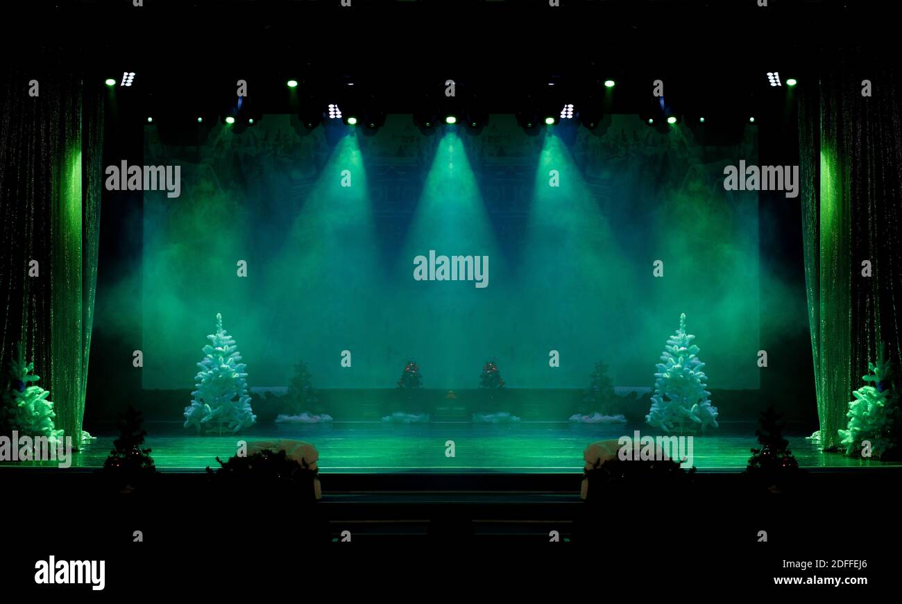 scene, stage light with colored spotlights and smoke, christmas tree ...