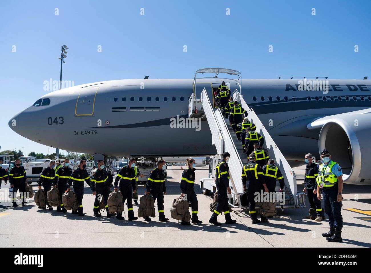Hand Out. French Civil Security personnel are seen boarding an Airbus ...