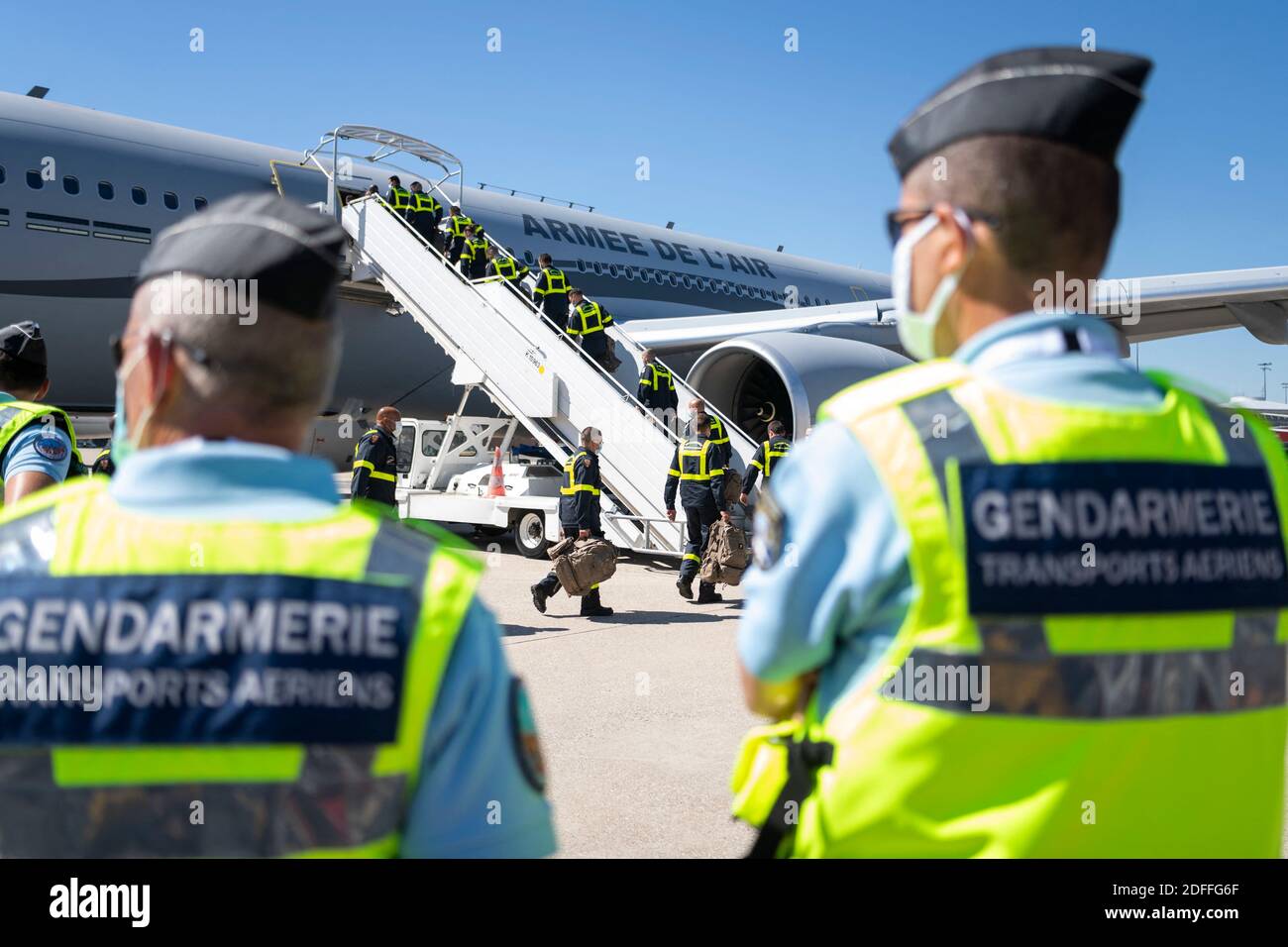 Hand Out. French Civil Security personnel are seen boarding an Airbus ...
