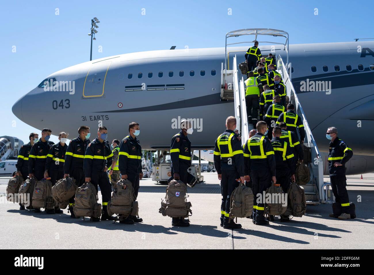 Hand Out. French Civil Security personnel are seen boarding an Airbus ...