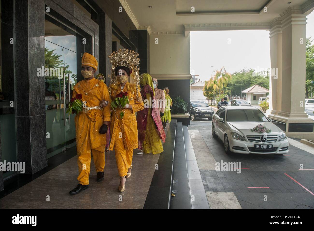 A married couple seen using face shield in carrying out a wedding ...