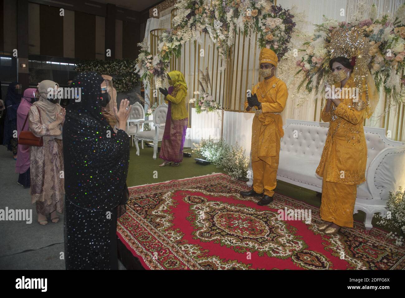 A married couple seen using face shield in carrying out a wedding ...