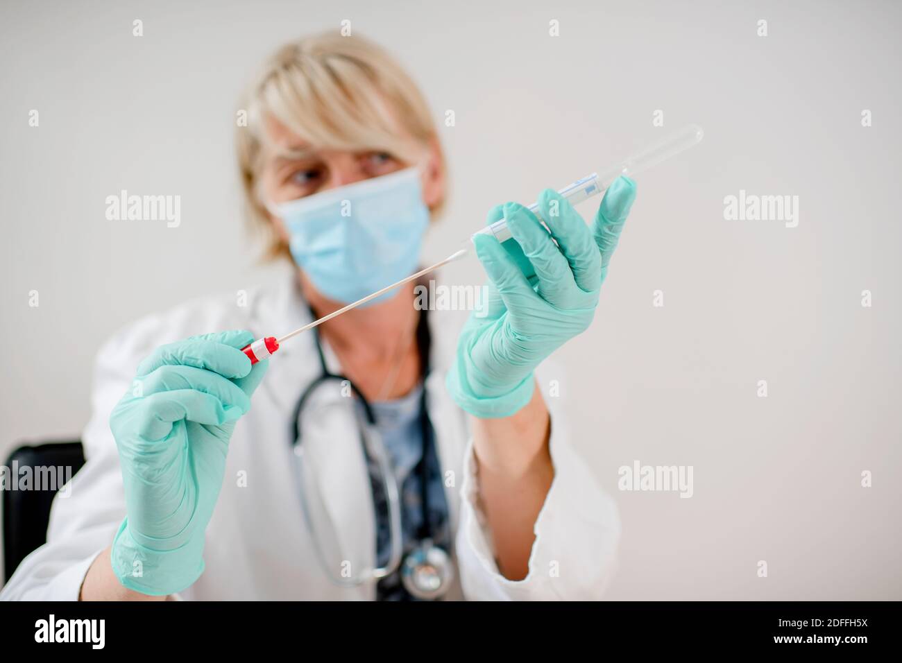 Female doctor preparing cotton swab Stock Photo - Alamy