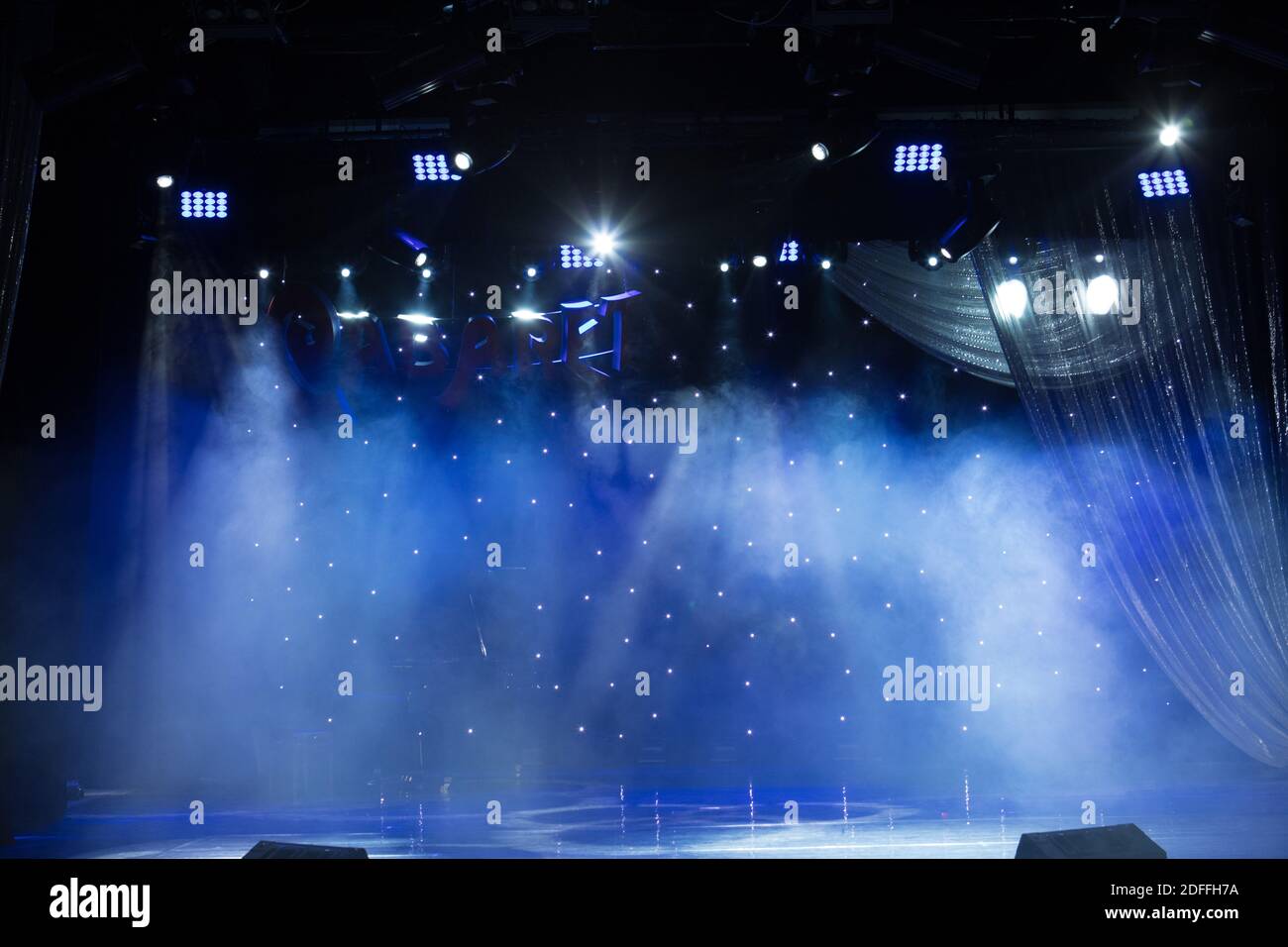 An empty stage of the theater, lit by spotlights and smoke before the ...