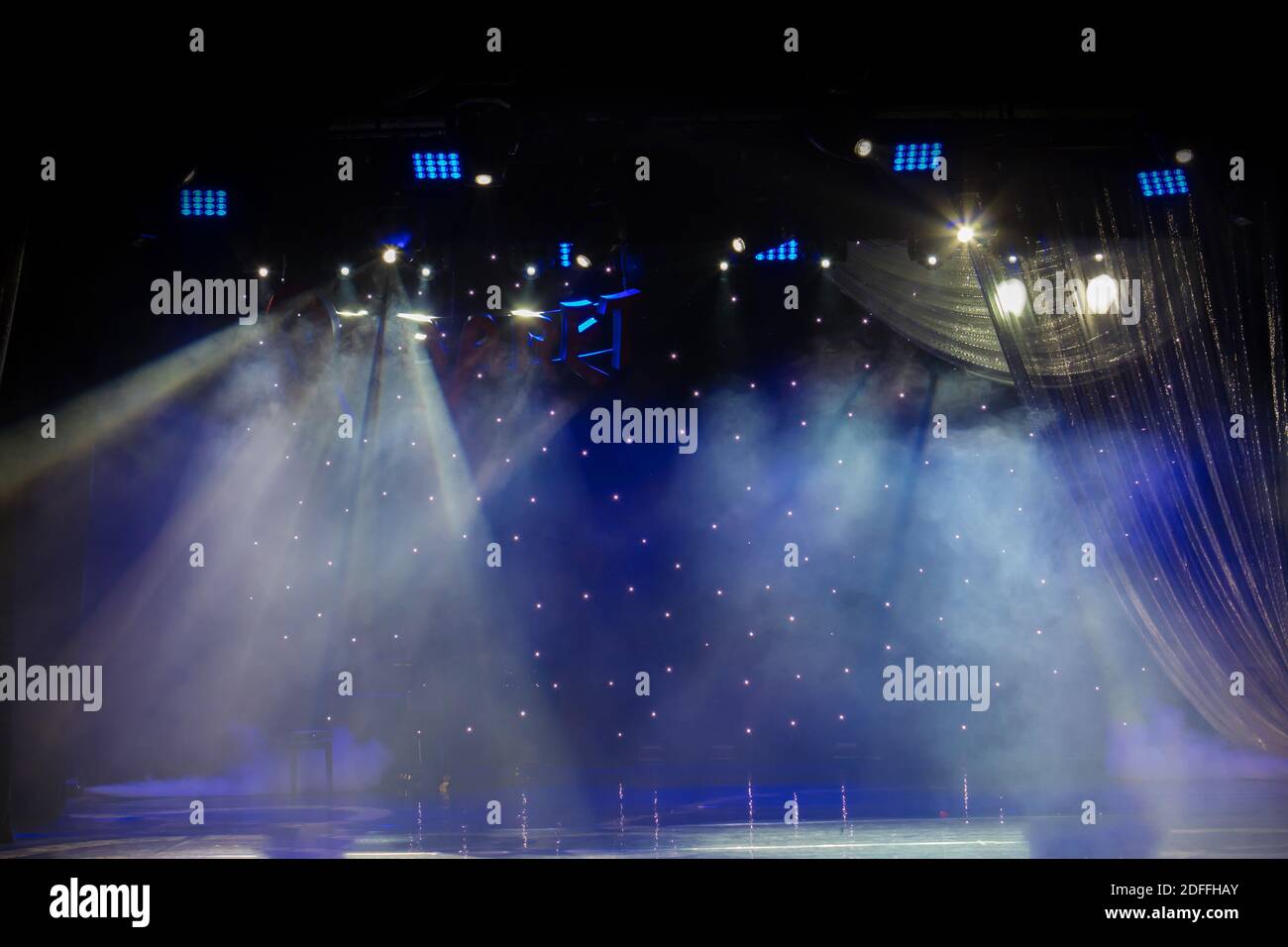An empty stage of the theater, lit by spotlights and smoke before the ...