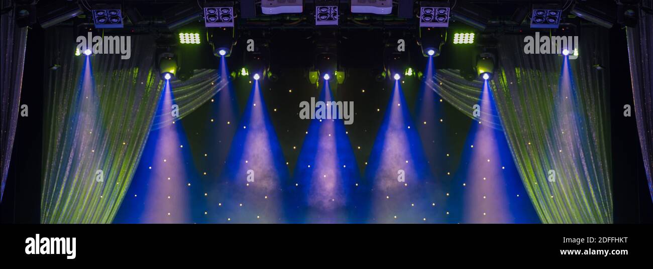 An empty stage of the theater, lit by spotlights and smoke before the ...