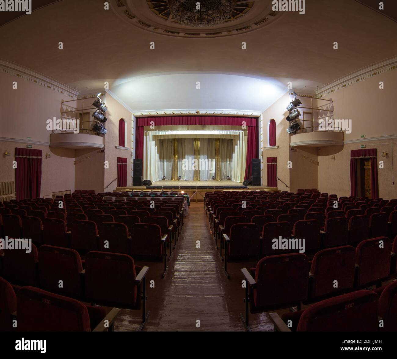 An empty stage of the theater, lit by spotlights and smoke before the ...
