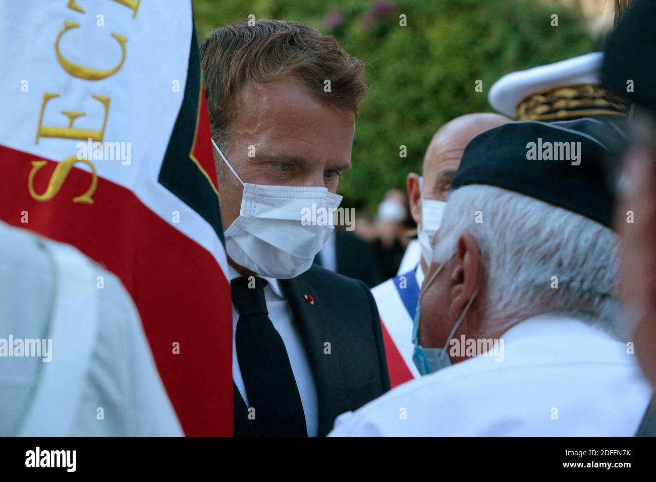 French President Emmanuel Macron, wearing a face mask, marks the 76th ...