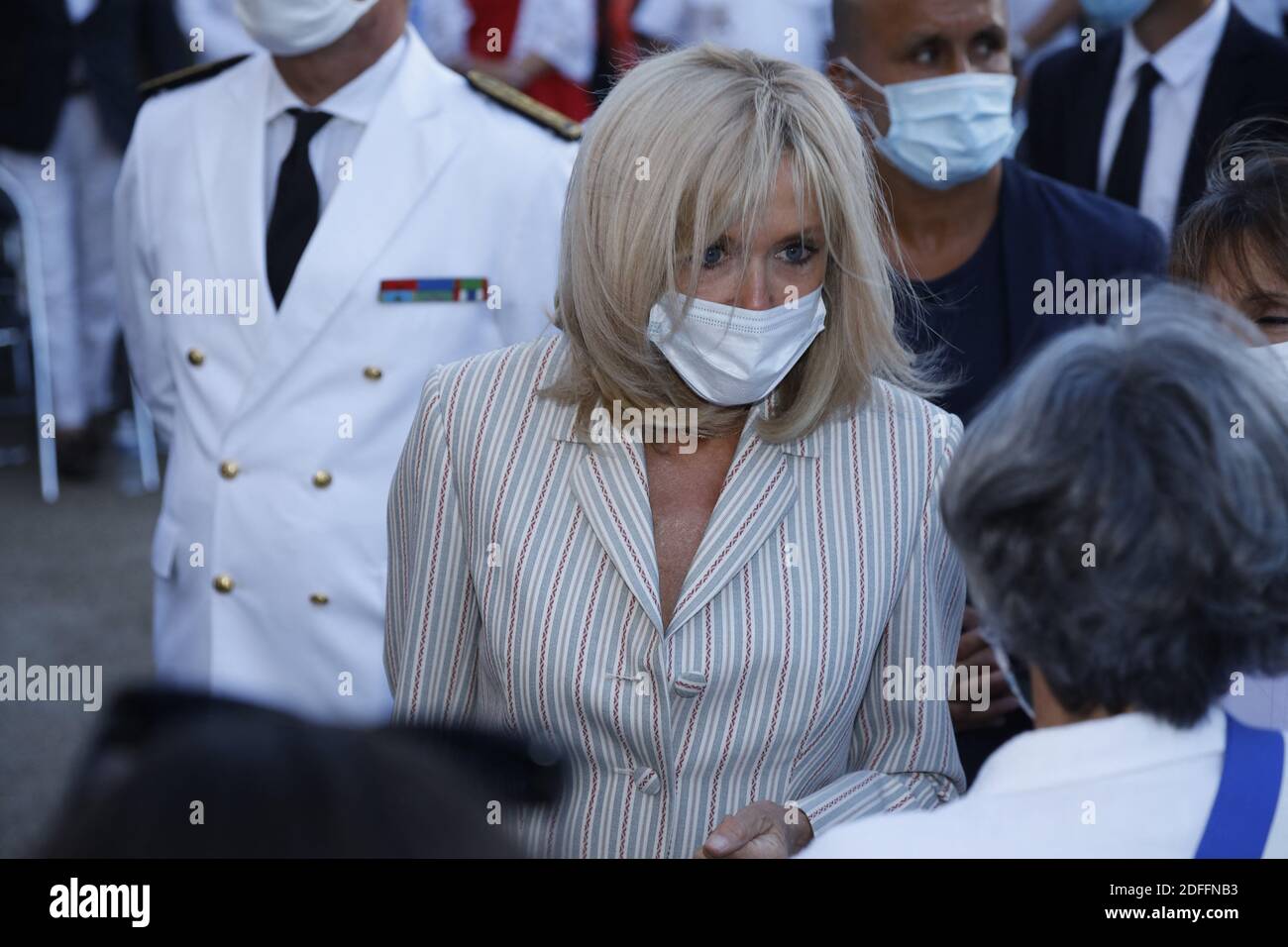 French President’s wife Brigitte Macron, wearing a face mask, attends a ...