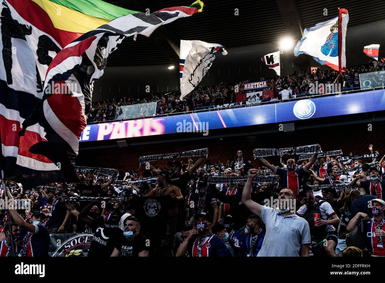 Paris Saint-Germain (PSG) supporters cheer for their team as they watch ...