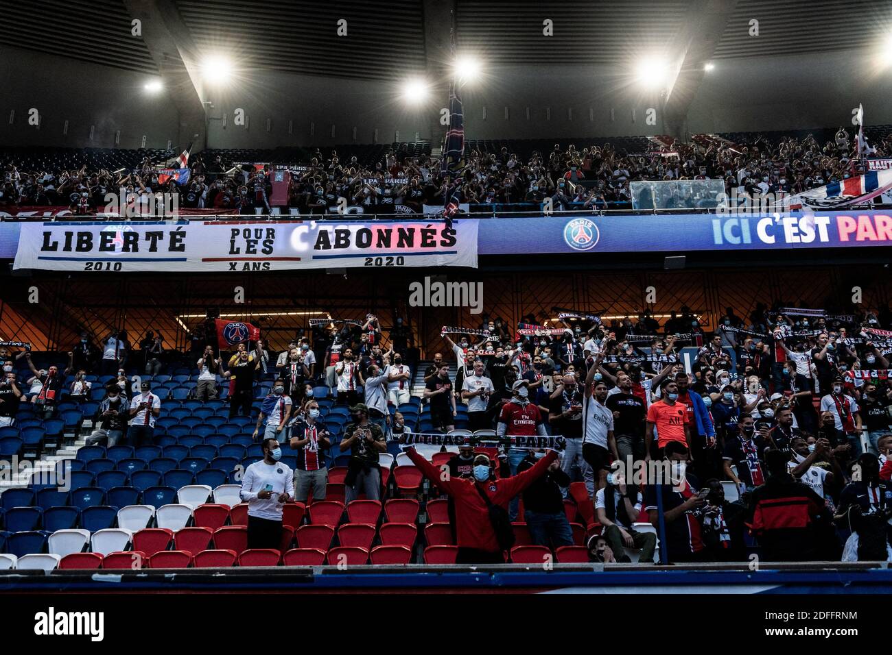Paris Saint-Germain (PSG) supporters cheer for their team as they watch ...