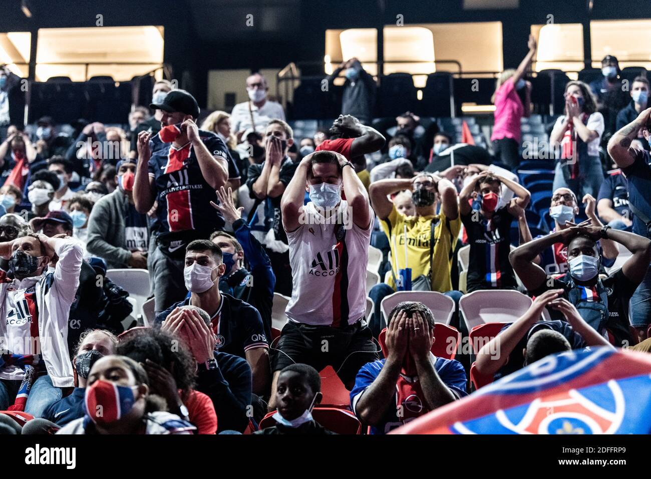 Paris Saint-Germain (PSG) supporters cheer for their team as they watch ...