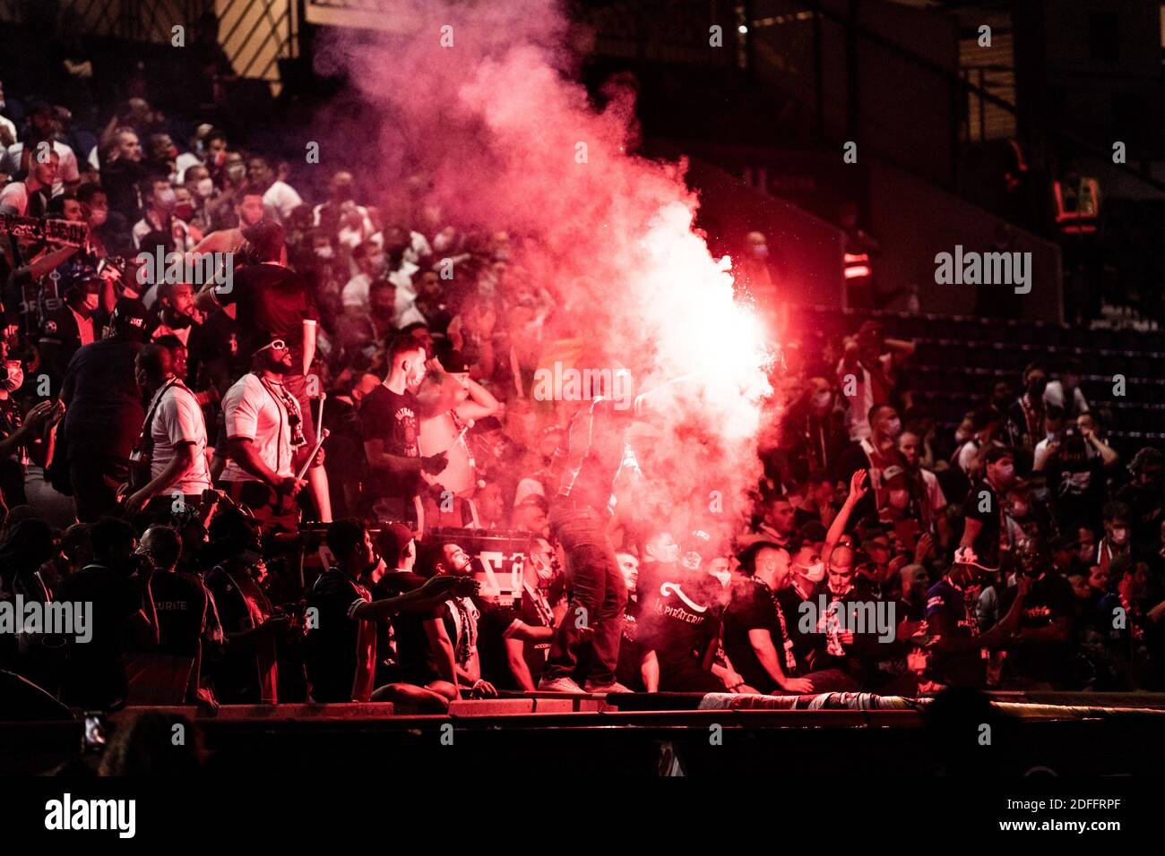 Paris Saint-Germain (PSG) supporters cheer for their team as they watch ...