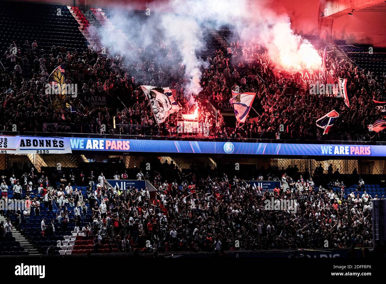 Paris Saint-Germain (PSG) supporters cheer for their team as they watch ...