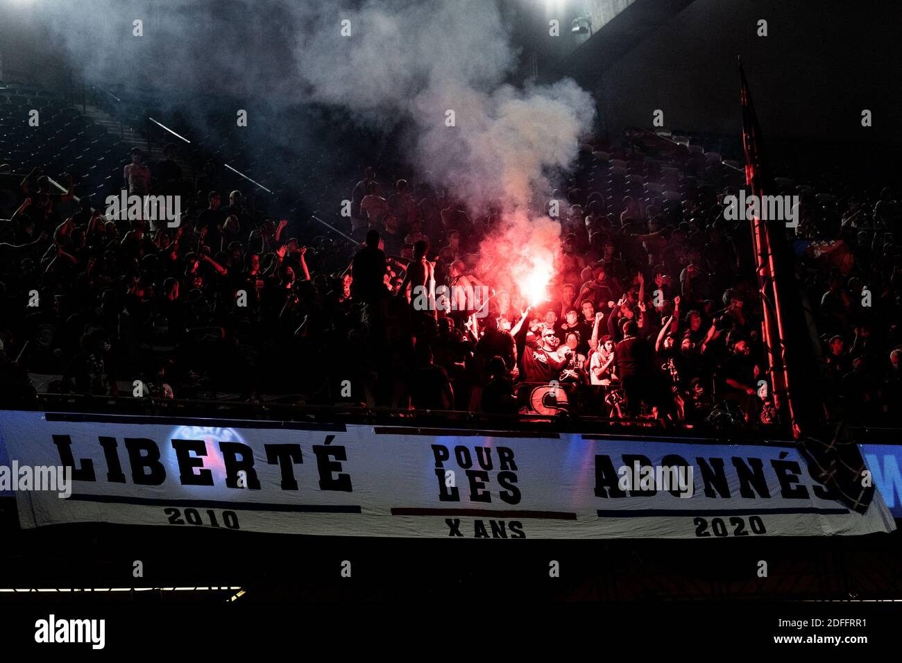 Paris Saint-Germain (PSG) supporters cheer for their team as they watch ...