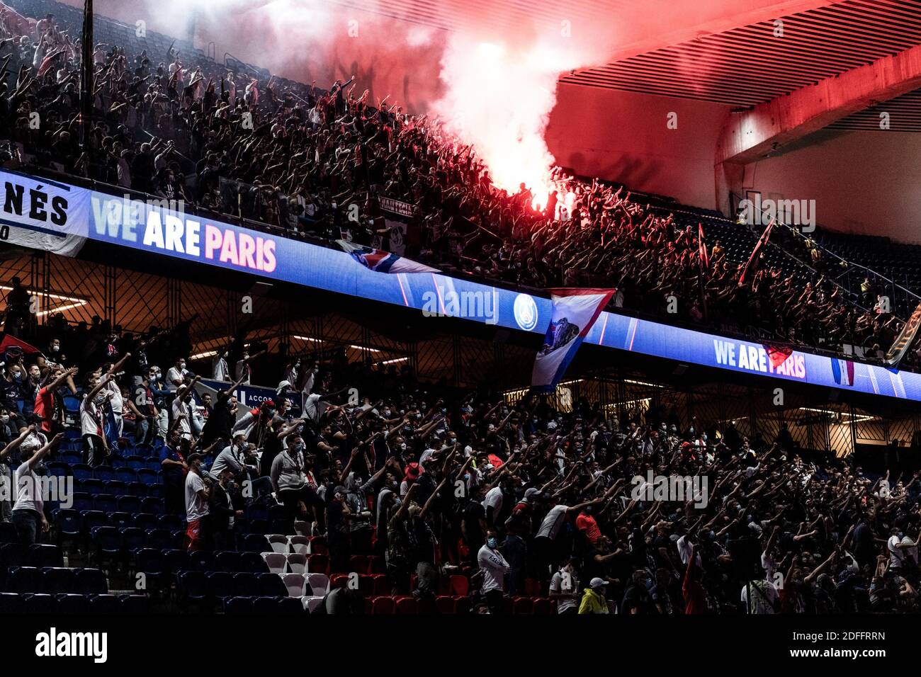 Paris Saint-Germain (PSG) supporters cheer for their team as they watch ...
