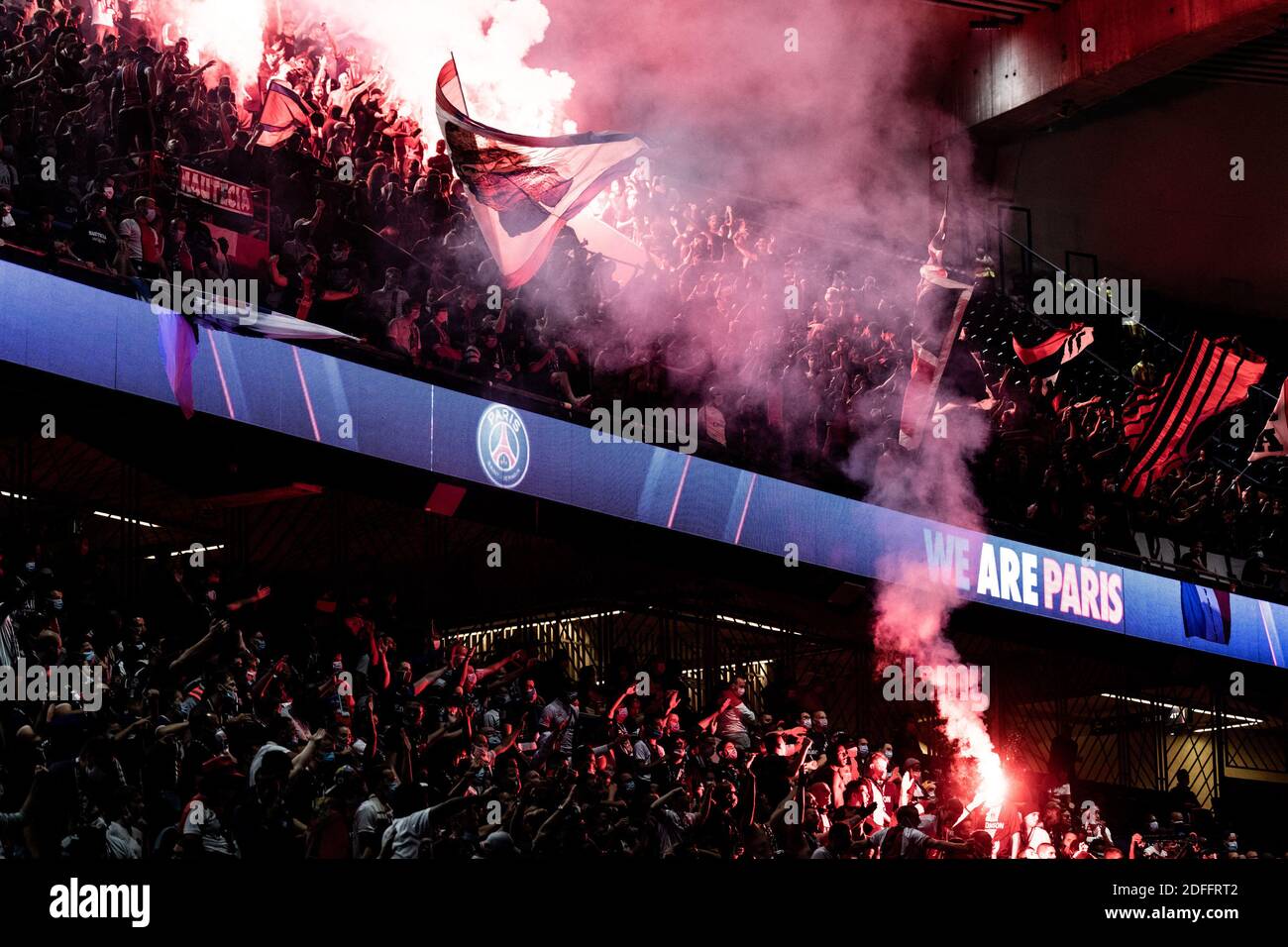Paris Saint-Germain (PSG) supporters cheer for their team as they watch ...