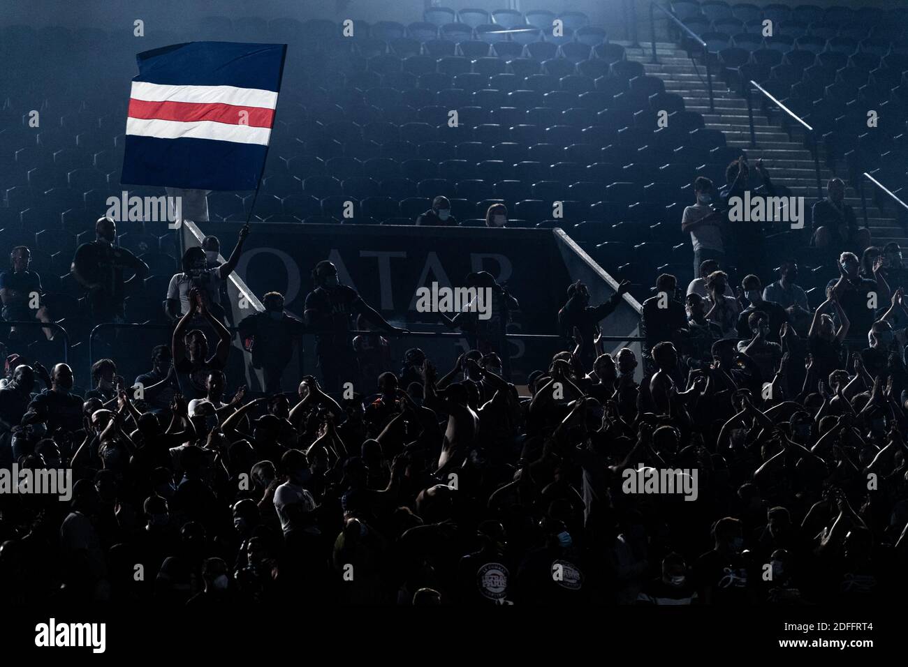 Paris Saint-Germain (PSG) supporters cheer for their team as they watch ...