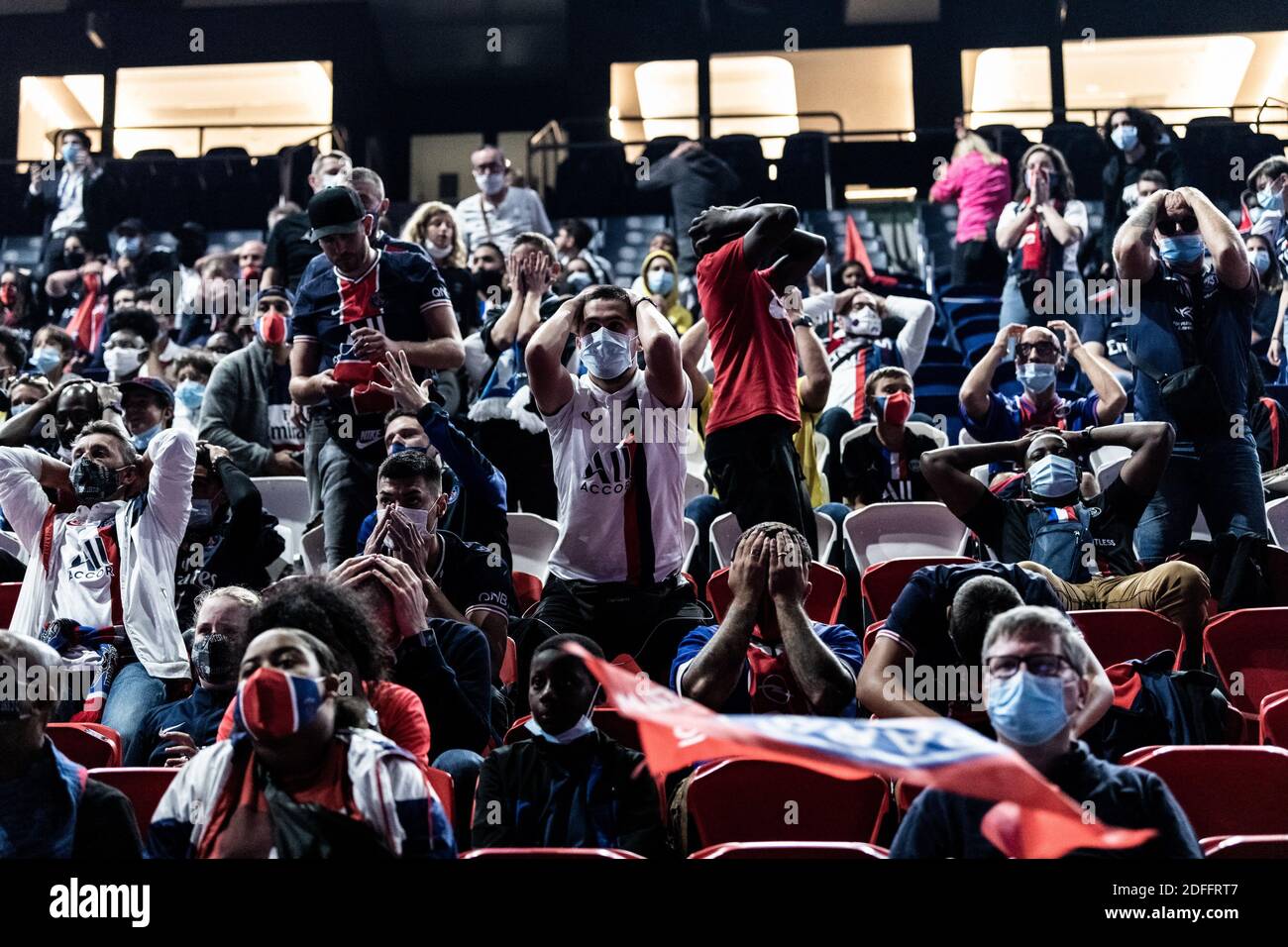 Paris Saint-Germain (PSG) supporters cheer for their team as they watch ...