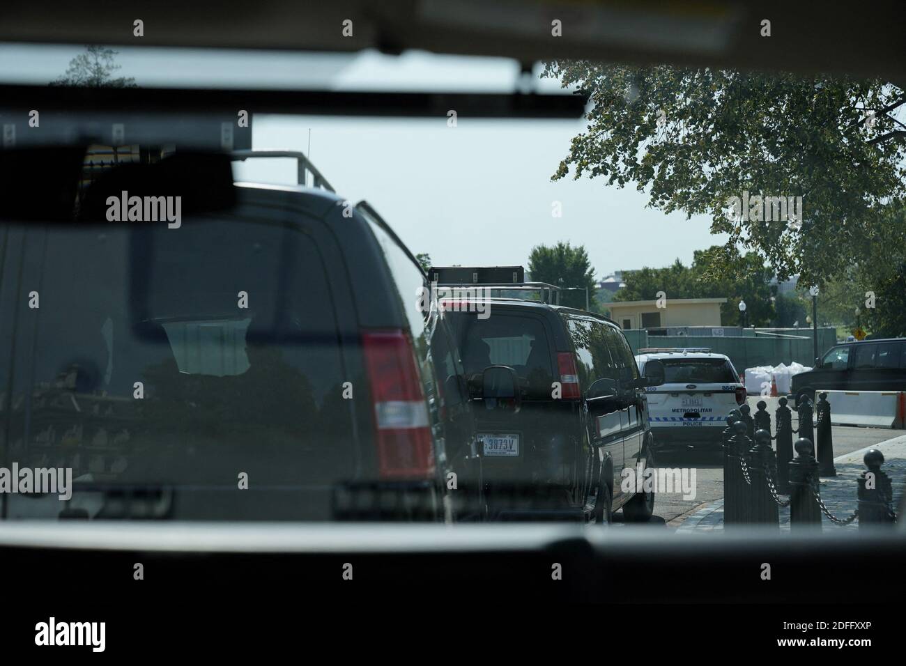 Motorcade of vans carrying White House press members heading to Trump ...