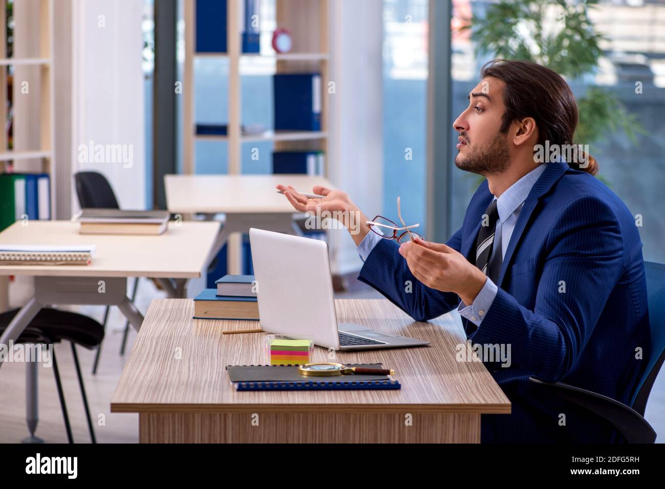 Young teacher in suit in the classroom Stock Photo - Alamy