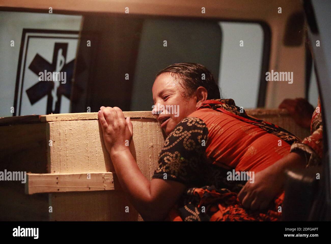 Relatives mourn in front of the coffin of Imon Hossain Imran, 30, at Sheikh Hasina National ...
