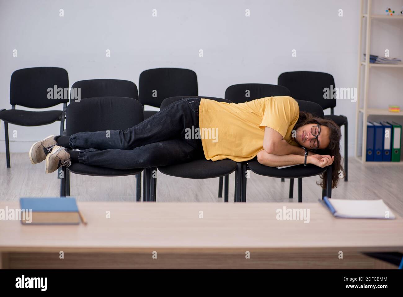 Young student waiting for teacher in the classroom Stock Photo - Alamy