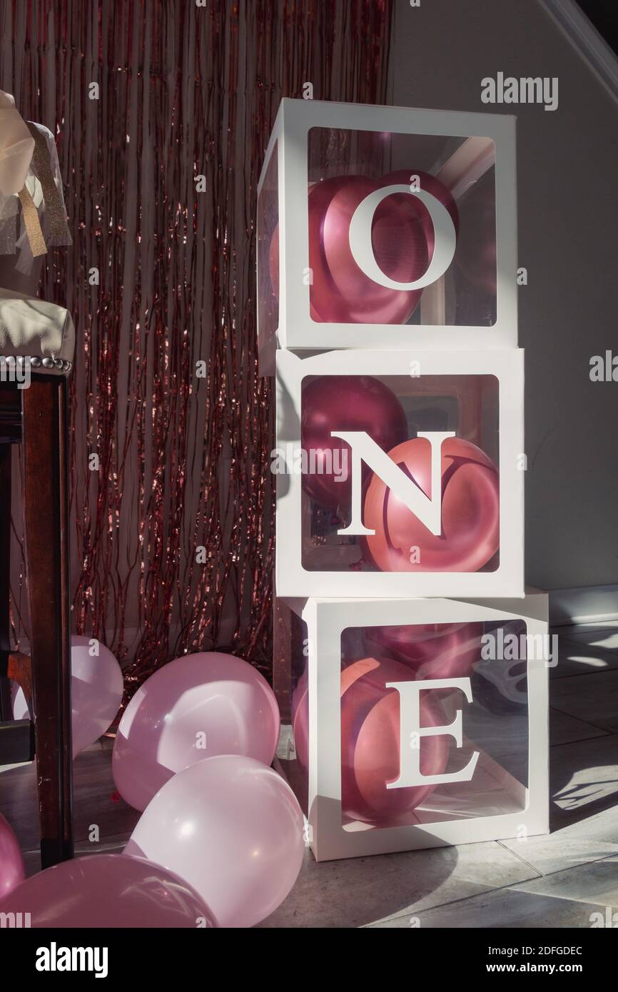 a vertical shot of transparent containers with balloons stack on each ...