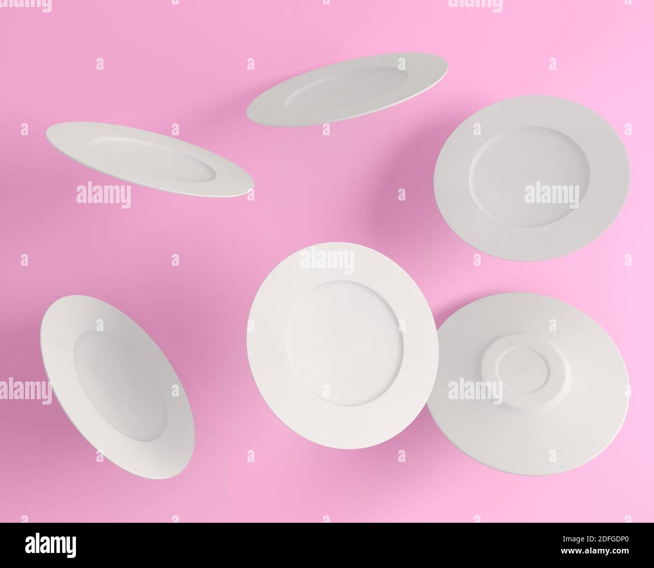 the multiple white plates in the air on a pink background Stock Photo ...