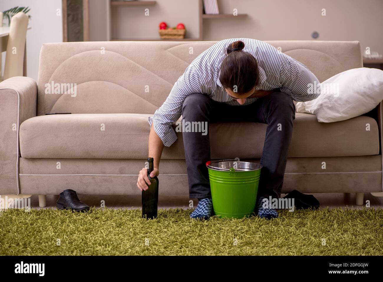 Young drunken man suffering at home Stock Photo - Alamy
