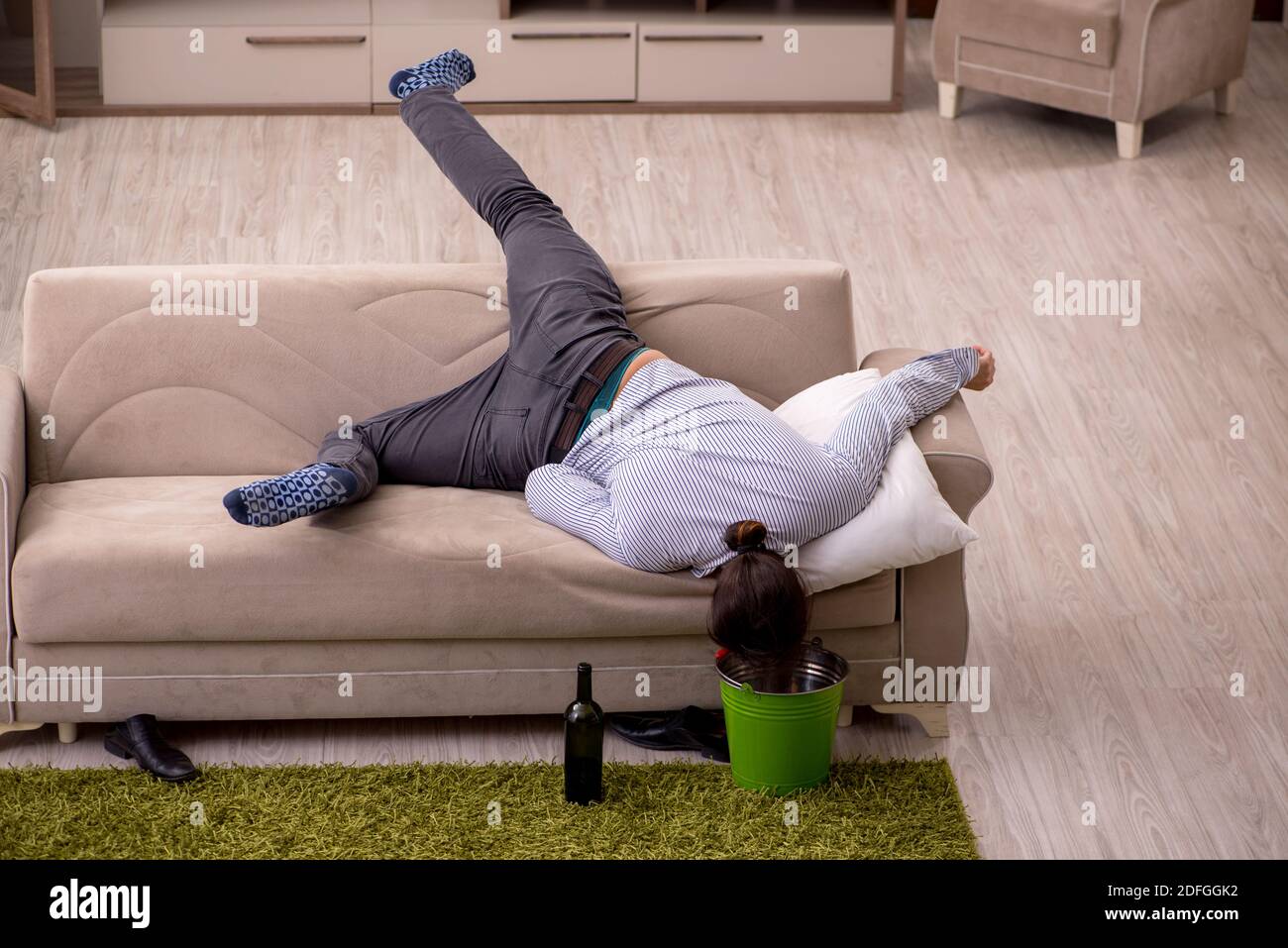 Young drunken man suffering at home Stock Photo - Alamy