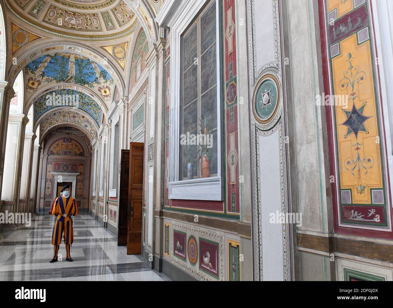 A Swiss Guard with a mask face stands in the first Raphael's Loggia in ...