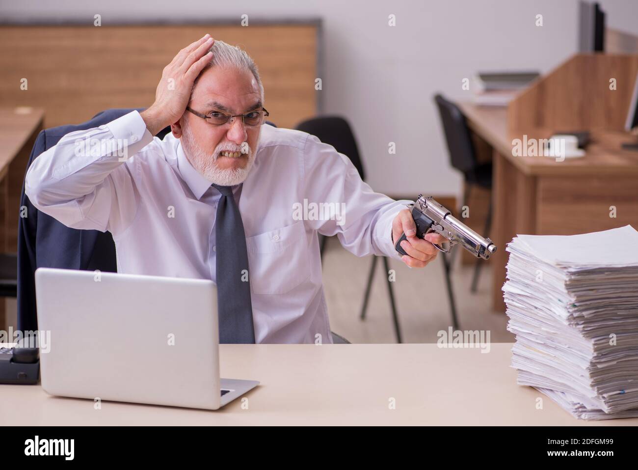Old employee being desperate with excessive work in the office Stock ...