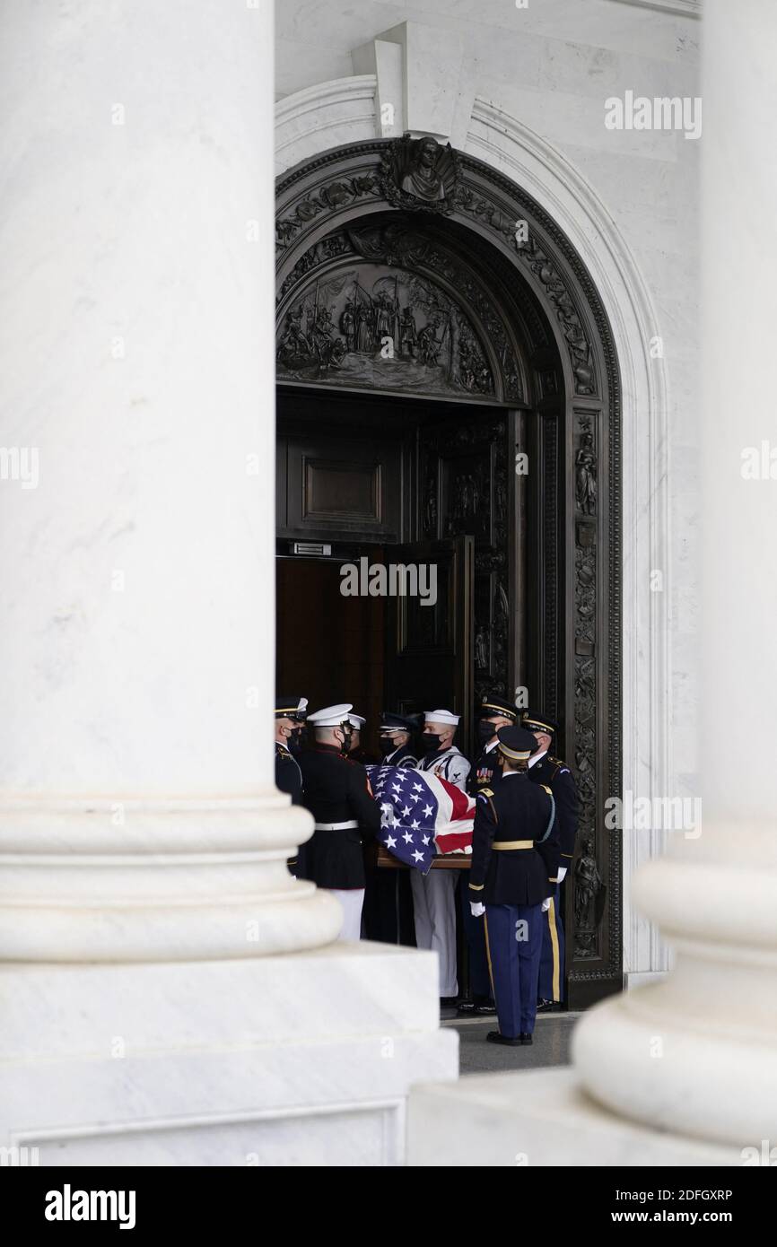The flag-draped casket of Justice Ruth Bader Ginsburg is carried by a ...