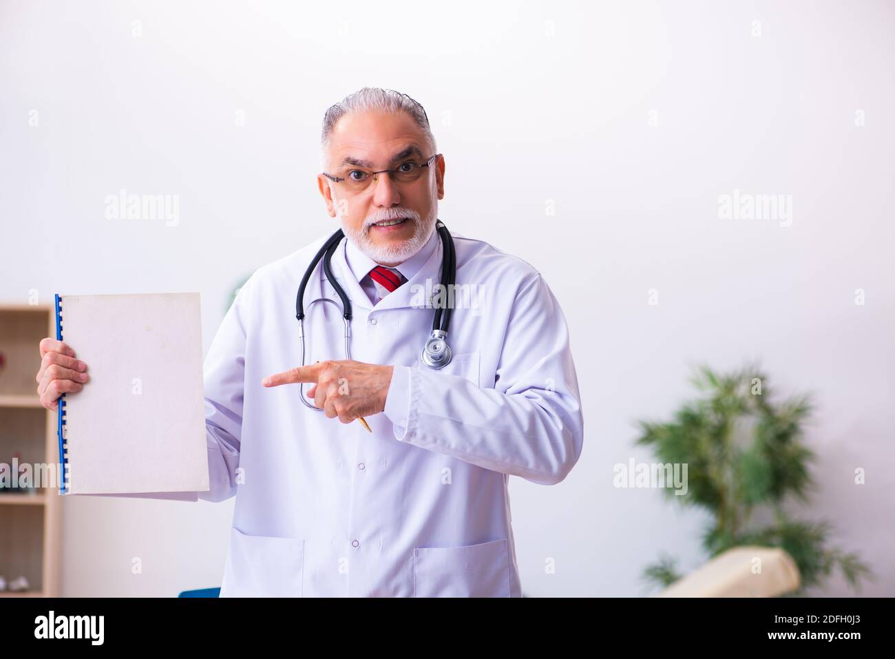 Old doctor working in the clinic Stock Photo - Alamy